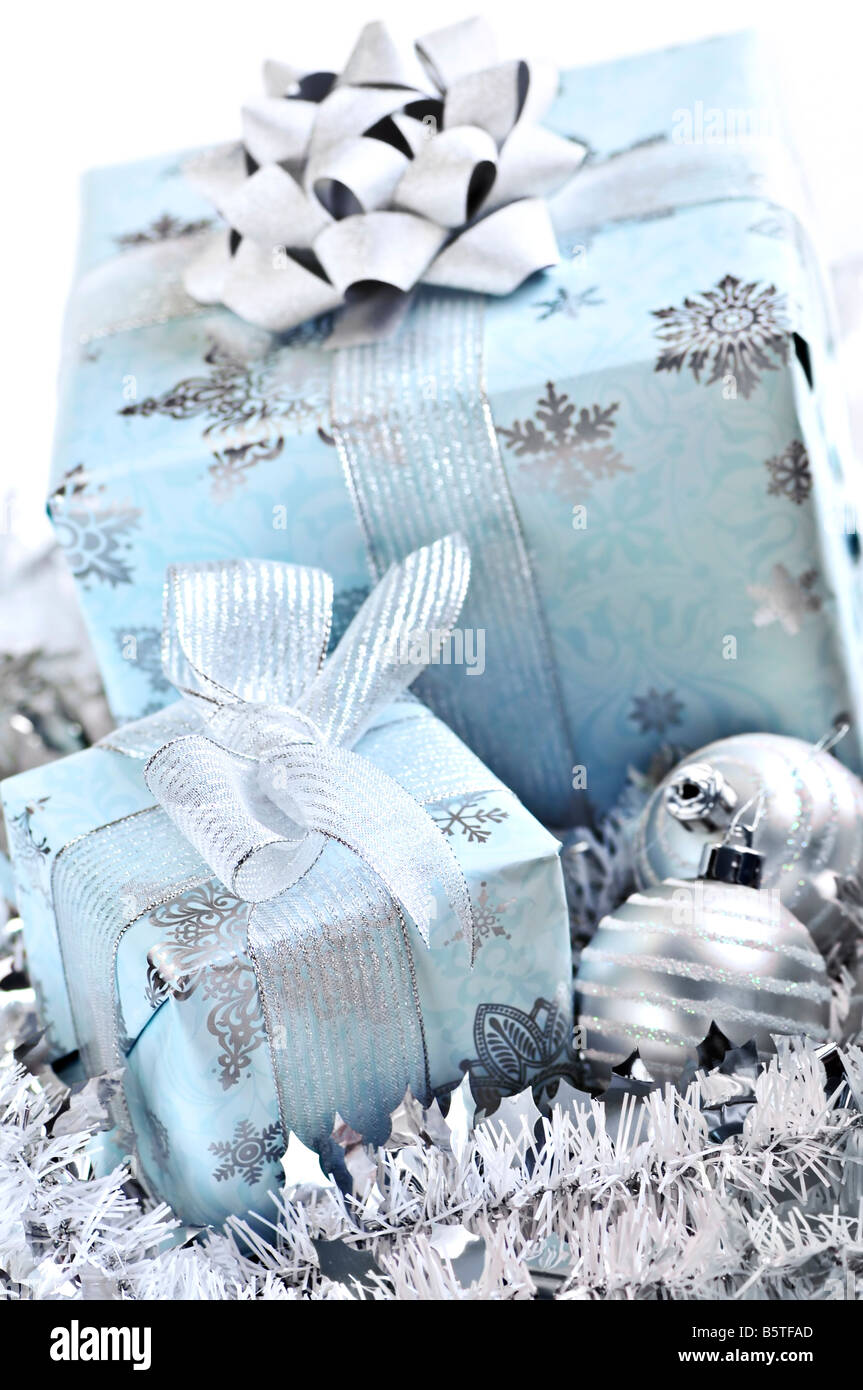 Wrapped gift boxes with silver Christmas ornaments on white background ...