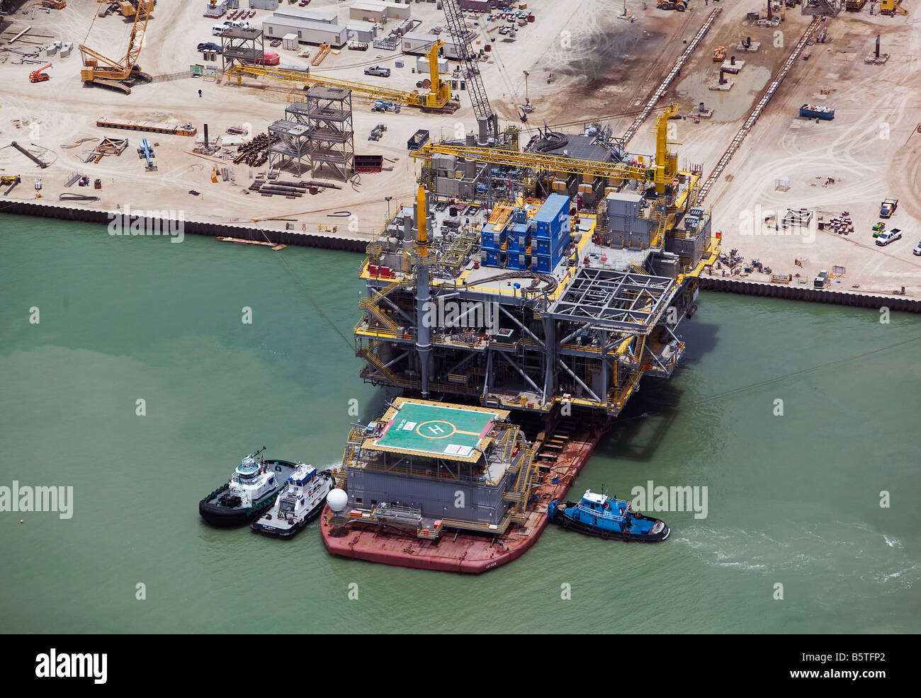 aerial view above tug boats at construction of oil rig Texas, Gulf of ...