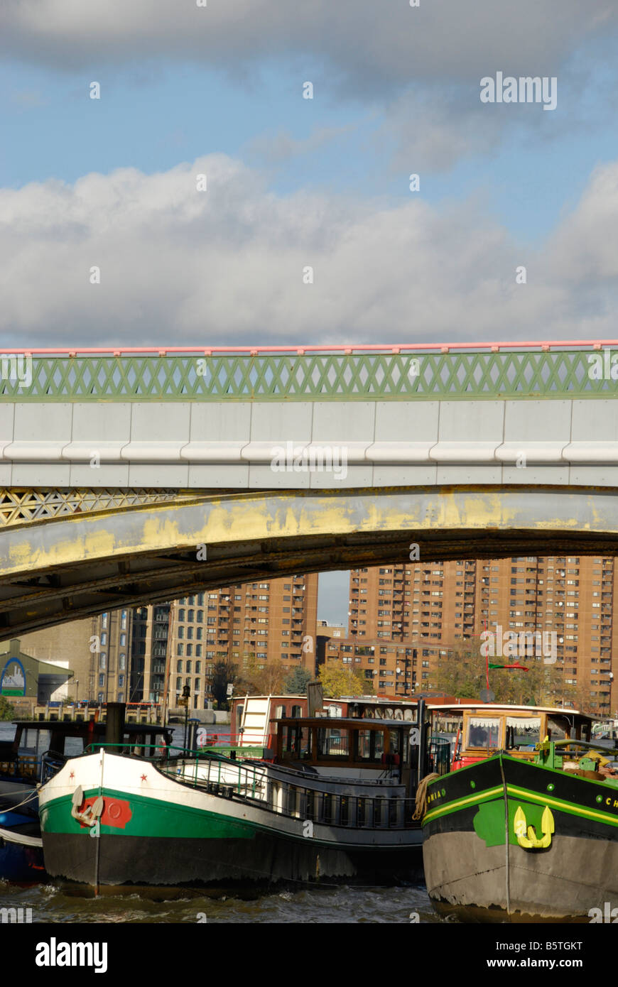 Boats underneath Battersea Reach Railway Bridge with Chelsea Harbour in ...