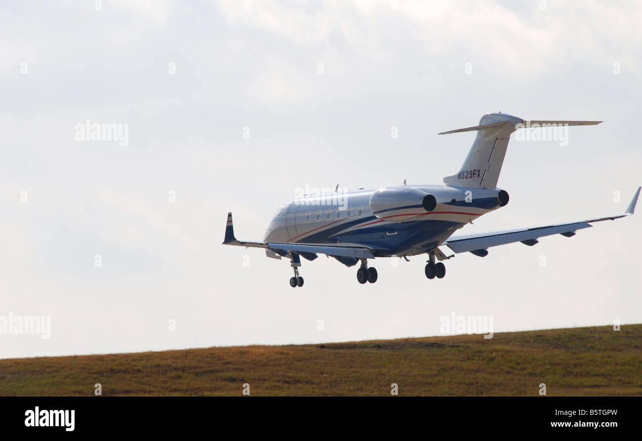 Small private business jet airplane landing at an airport Stock Photo ...