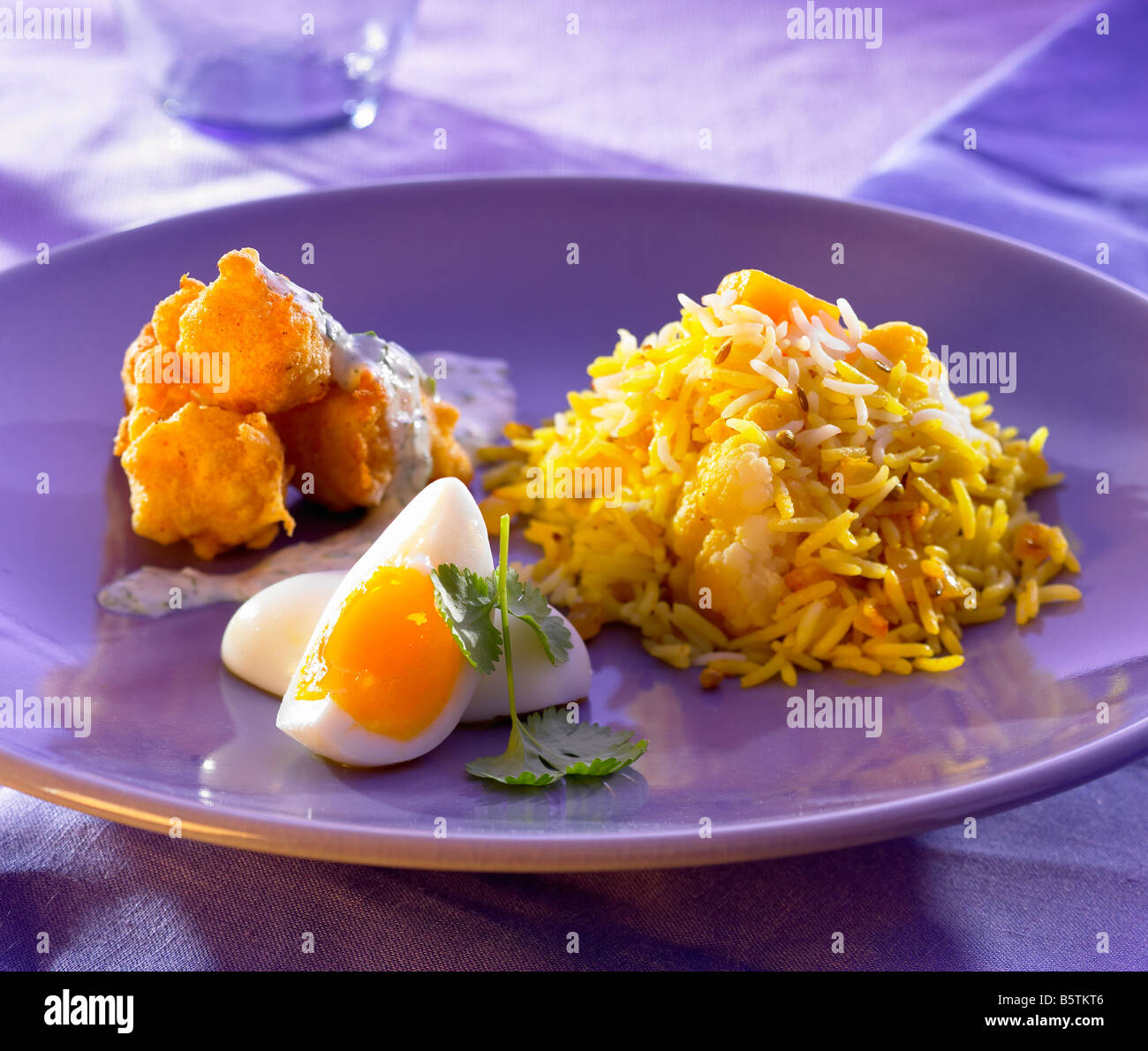 saffron rice with battered chicken pieces Stock Photo - Alamy