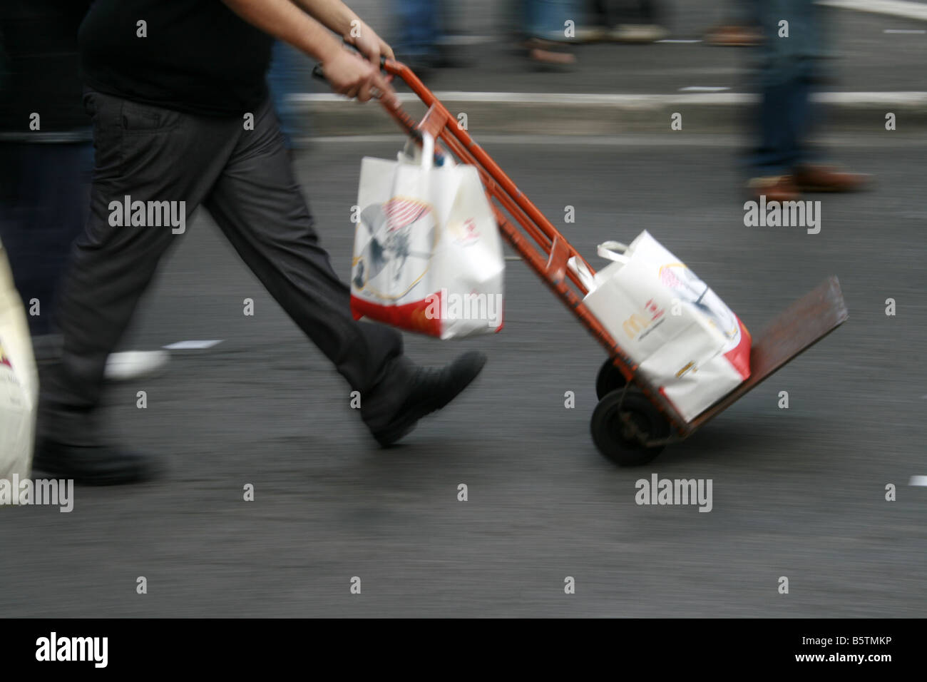 man pushing trolley with macdonalds take away food bags Stock Photo - Alamy