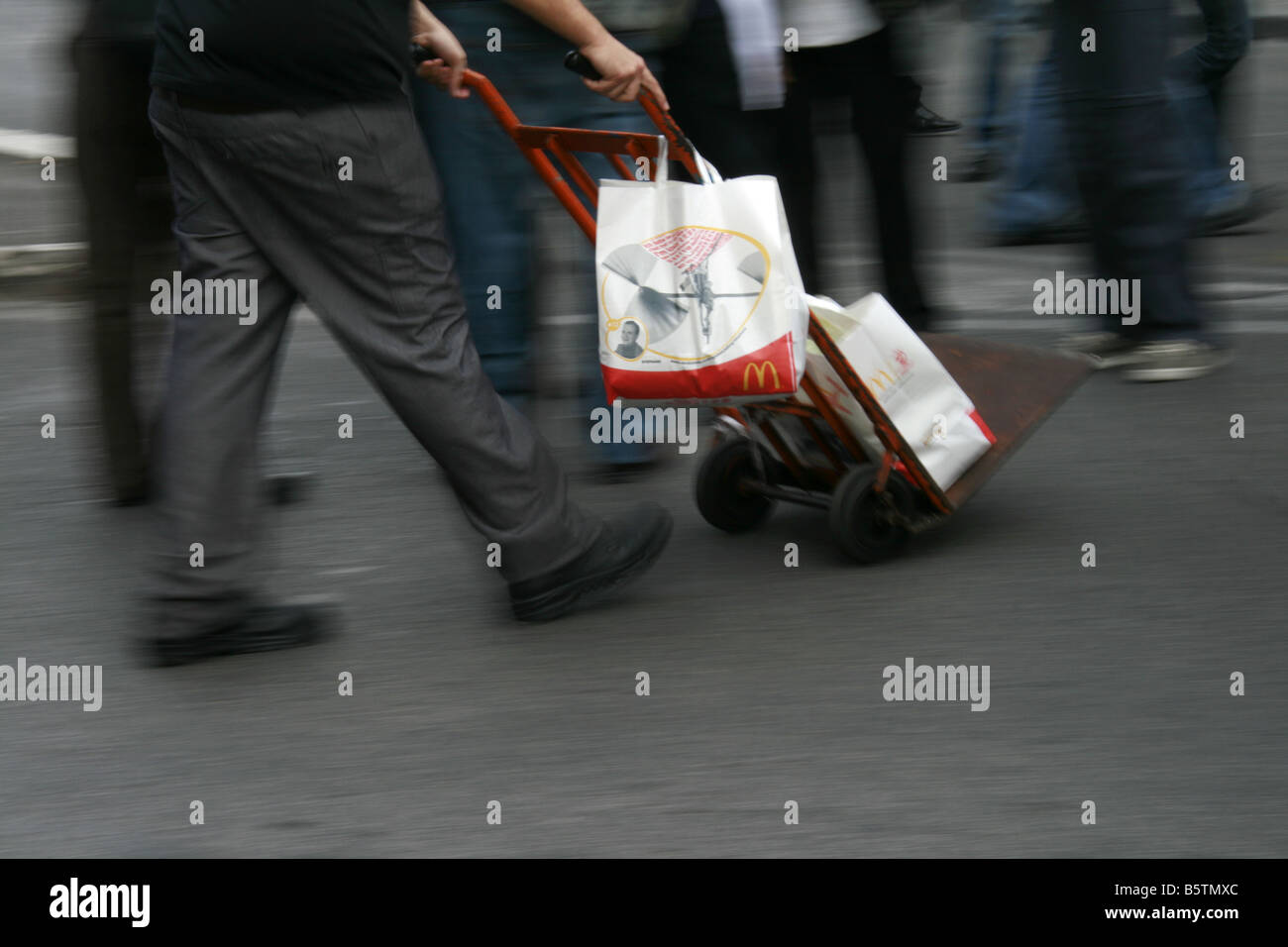 man pushing trolley with macdonalds take away food bags Stock Photo - Alamy