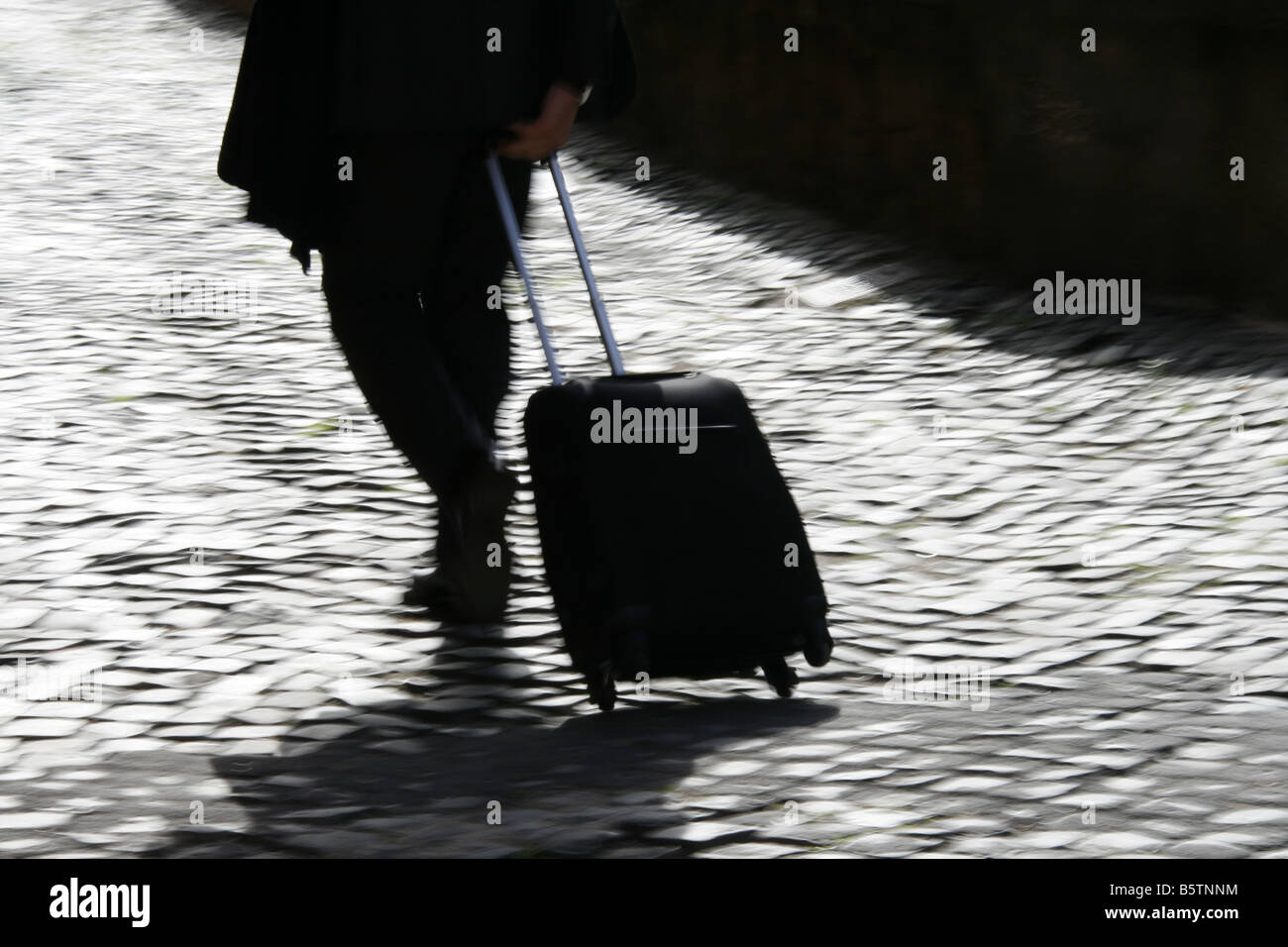 business man pulling trolley luggage case in town Stock Photo - Alamy