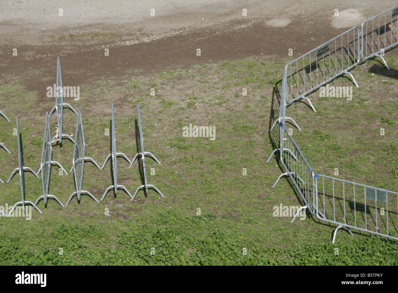 rows of many metal crowd control barriers gates in field Stock Photo ...