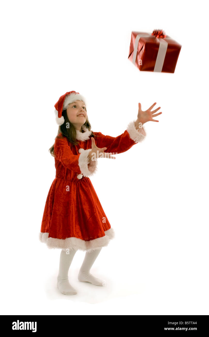 Young girl catching flying christmas gift Stock Photo - Alamy