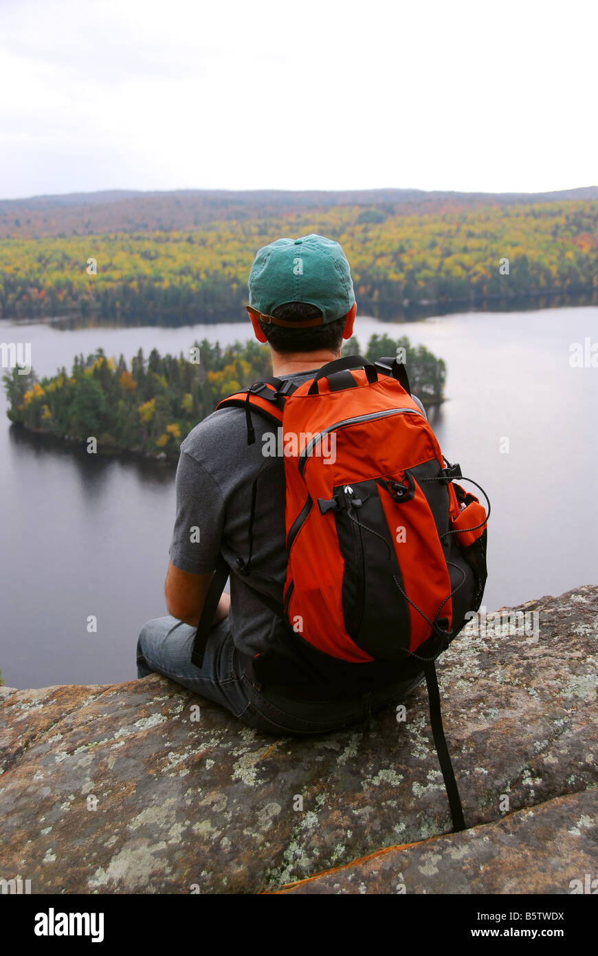Man on top of a hill enjoying a scenic view Stock Photo - Alamy