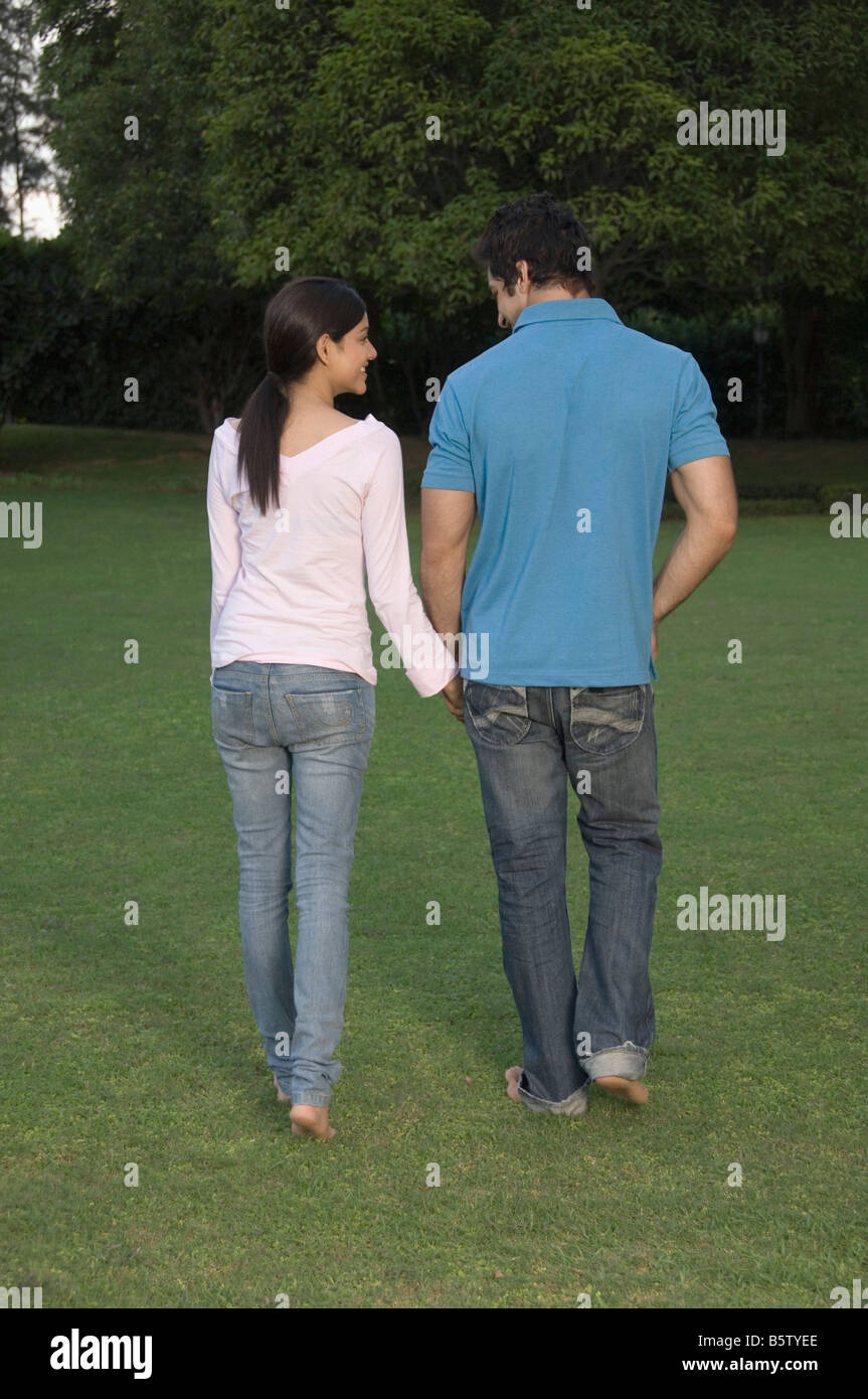 Rear view of a couple walking Stock Photo - Alamy