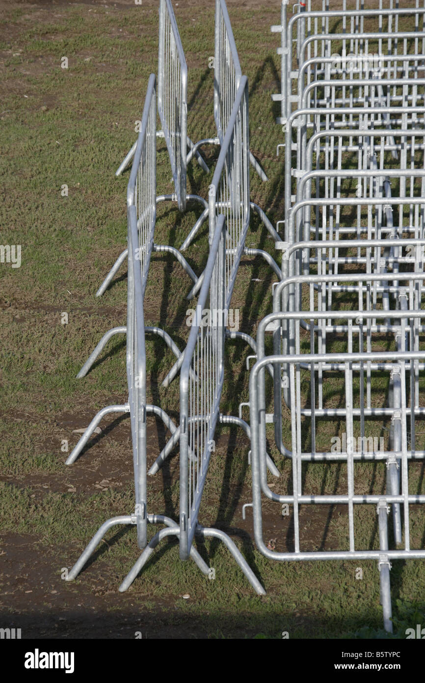 rows of many metal crowd control barriers gates in field Stock Photo ...
