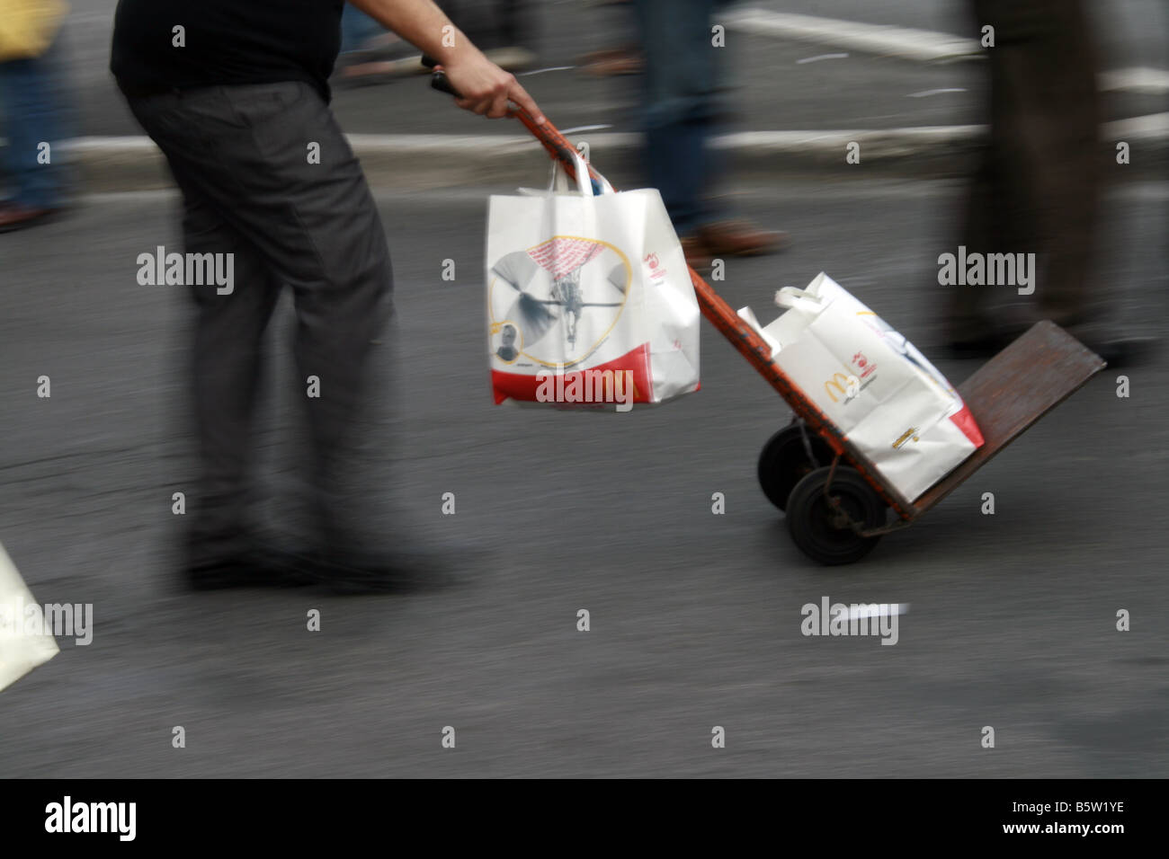 man pushing trolley with macdonalds take away food bags Stock Photo - Alamy