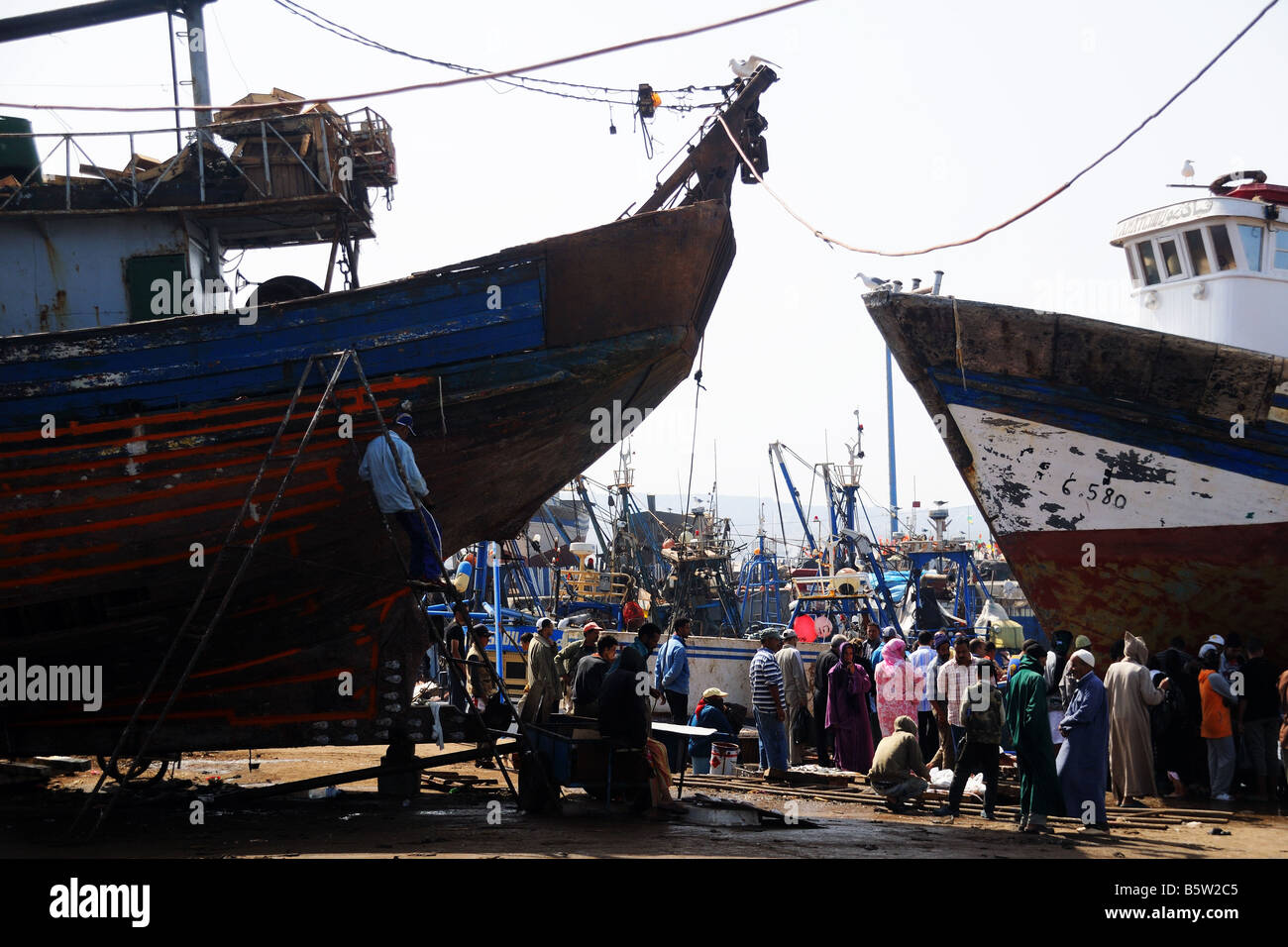 People waiting to board boats in Port Skala Fishing Harbour Essaouira ...