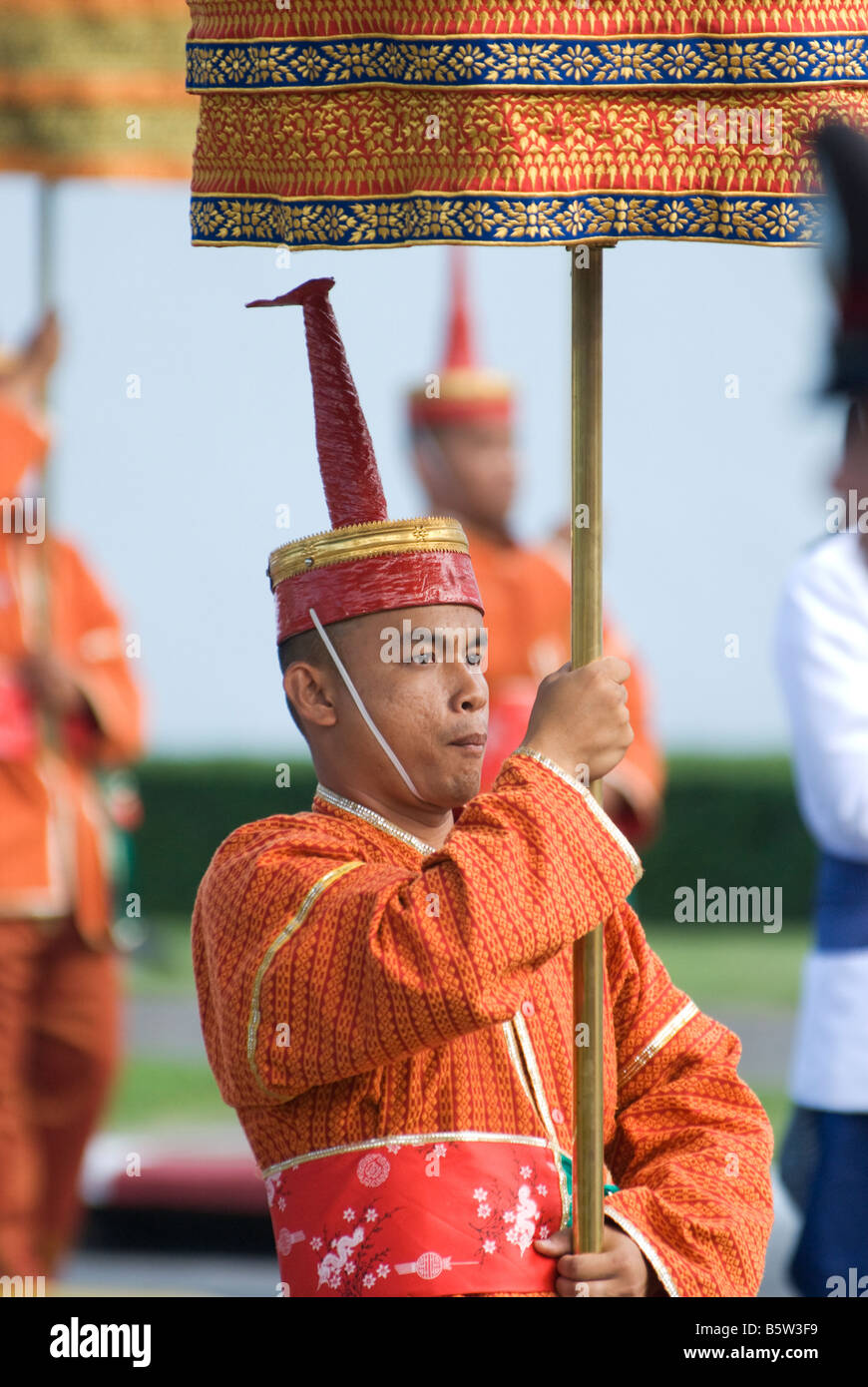 Bearer of a Tiered Gold embroidered Umbrella in traditional uniform in ...