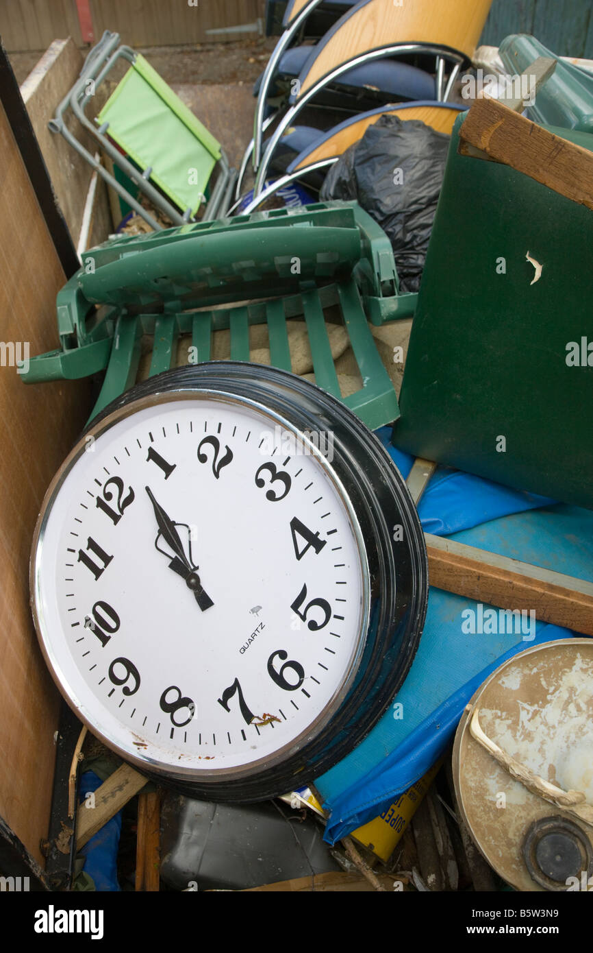 Waste of time old clock thrown away in a skip with other rubbish Stock ...