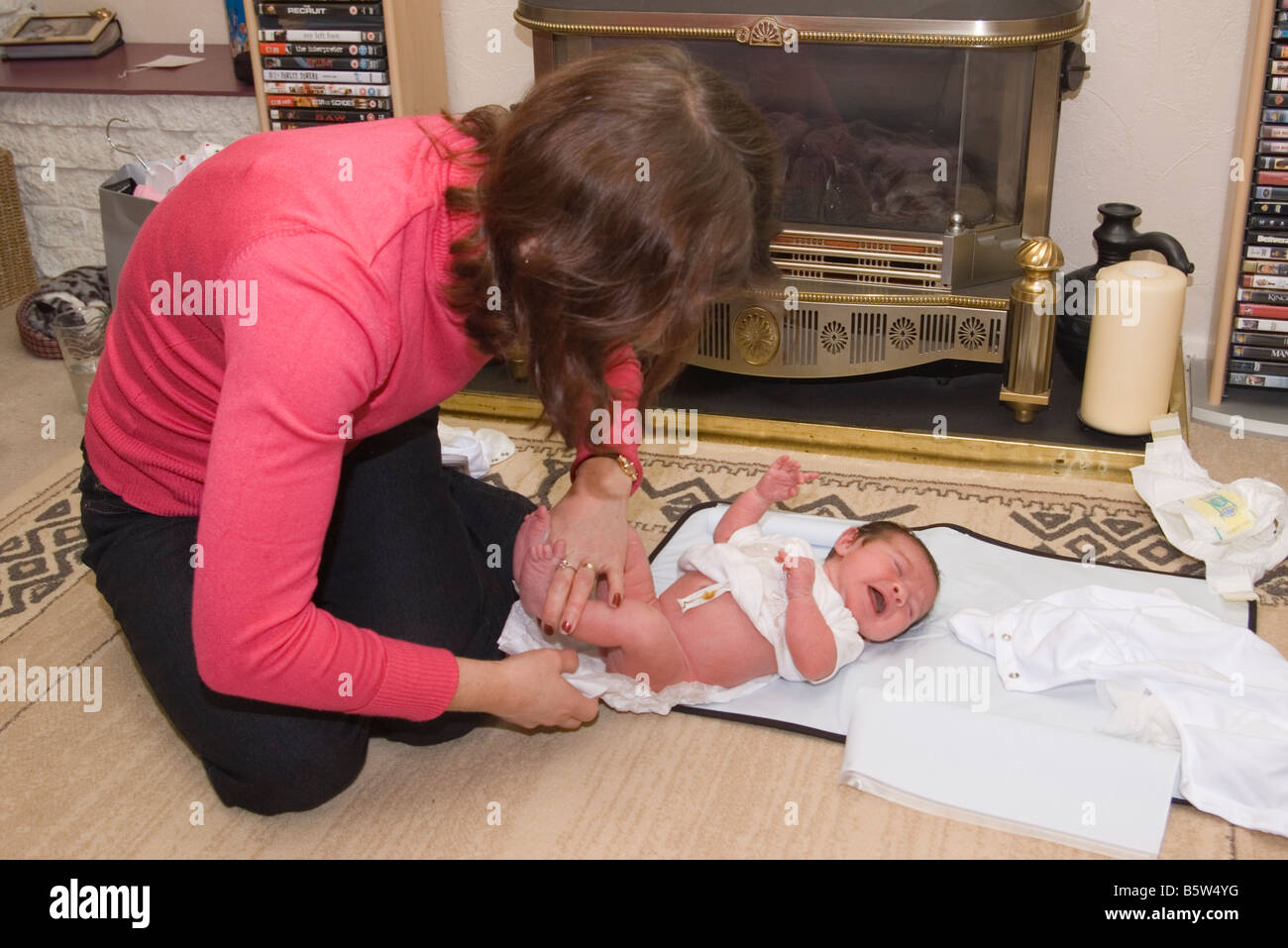 mother Woman Changing new born 1 Week Old Baby Child Daughters Nappy ...