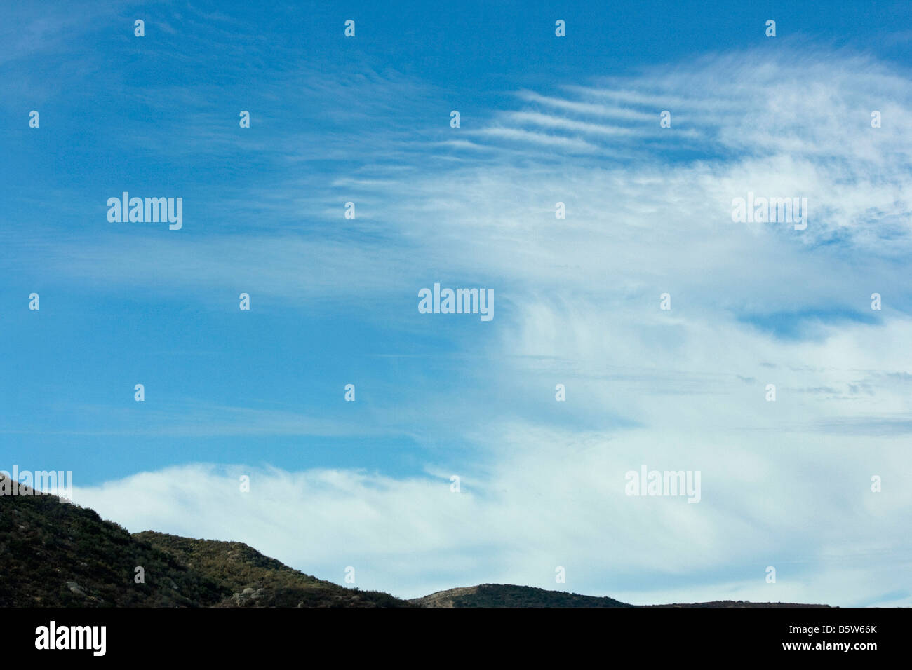 High desert community with trees mountains cloudy skies and or some ...