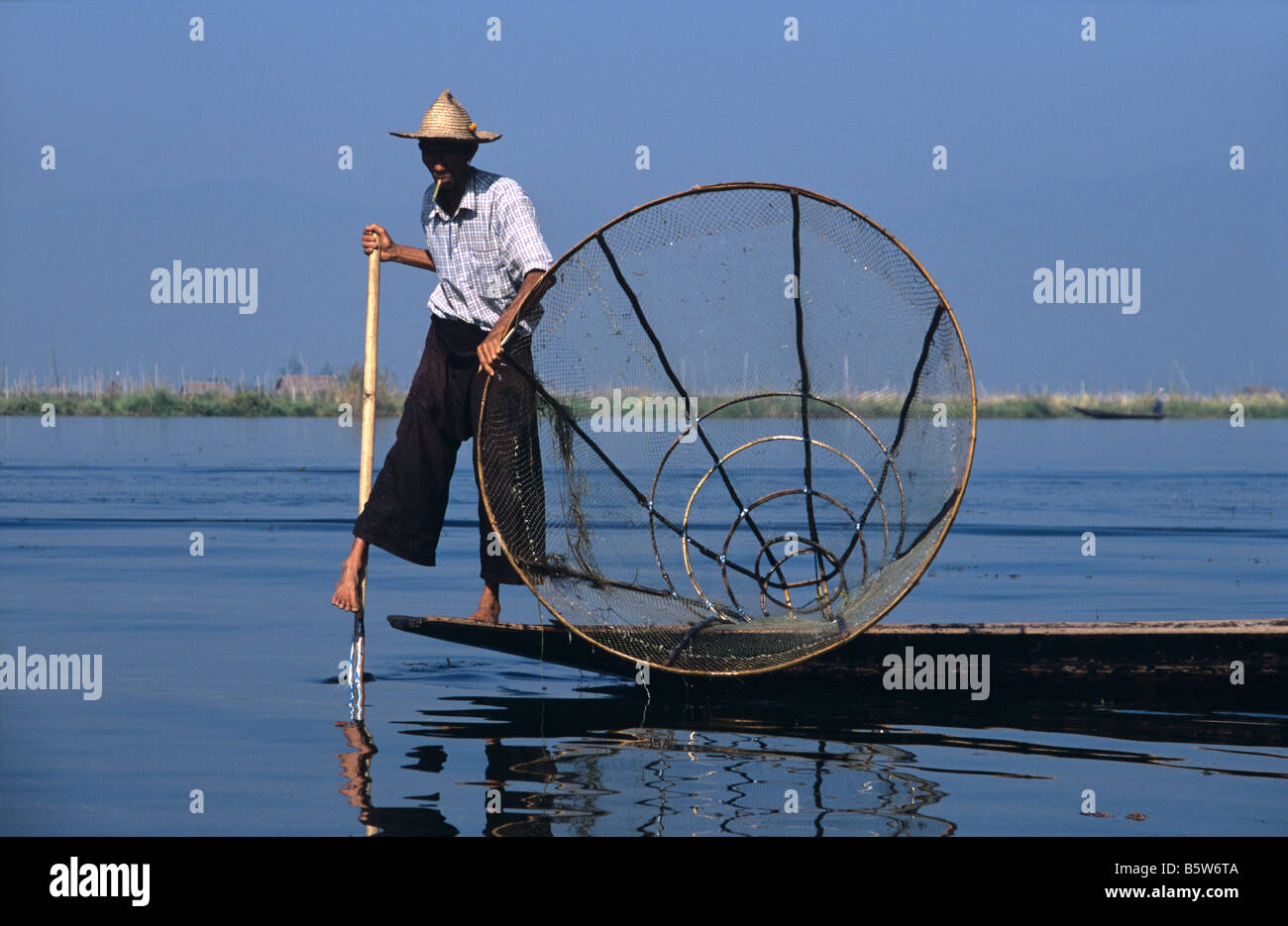 An Intha Leg Rowing Fisherman with his Long Boat and Cone-Shaped Net on ...