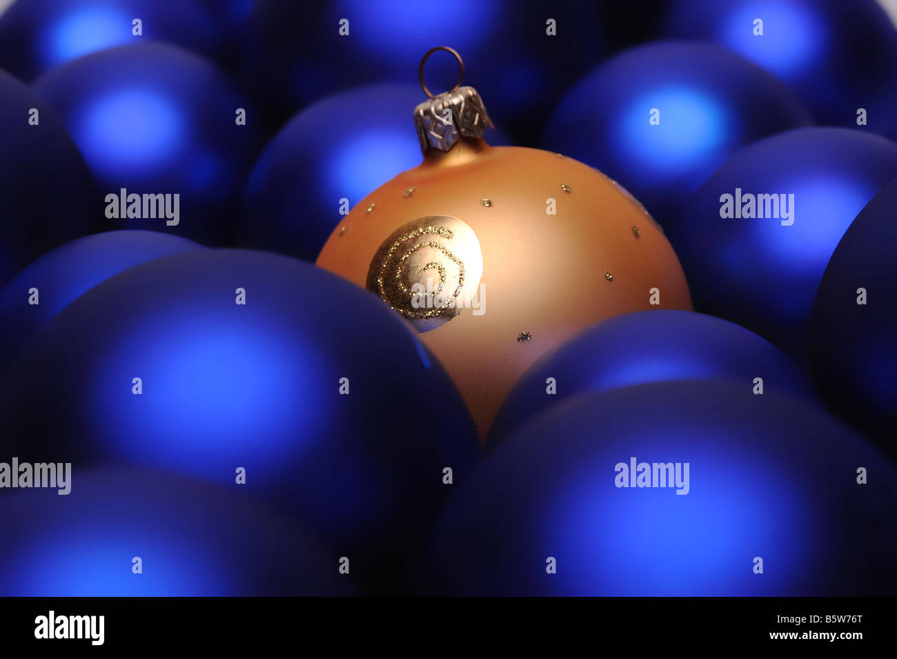 One golden Christmal ball in a group of blue christmas balls Stock ...