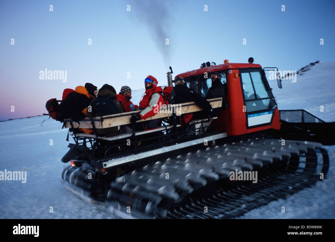 Mountaineers going up slopes of Mt Elbrus with a snowcat at altitude of ...