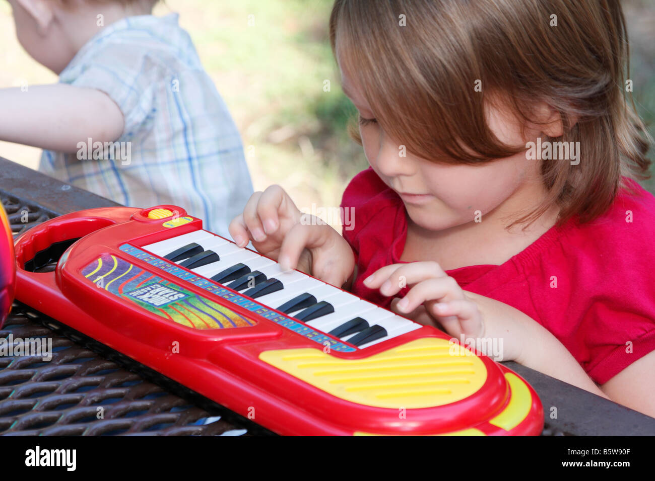 child playing music on a small keyboard Stock Photo - Alamy