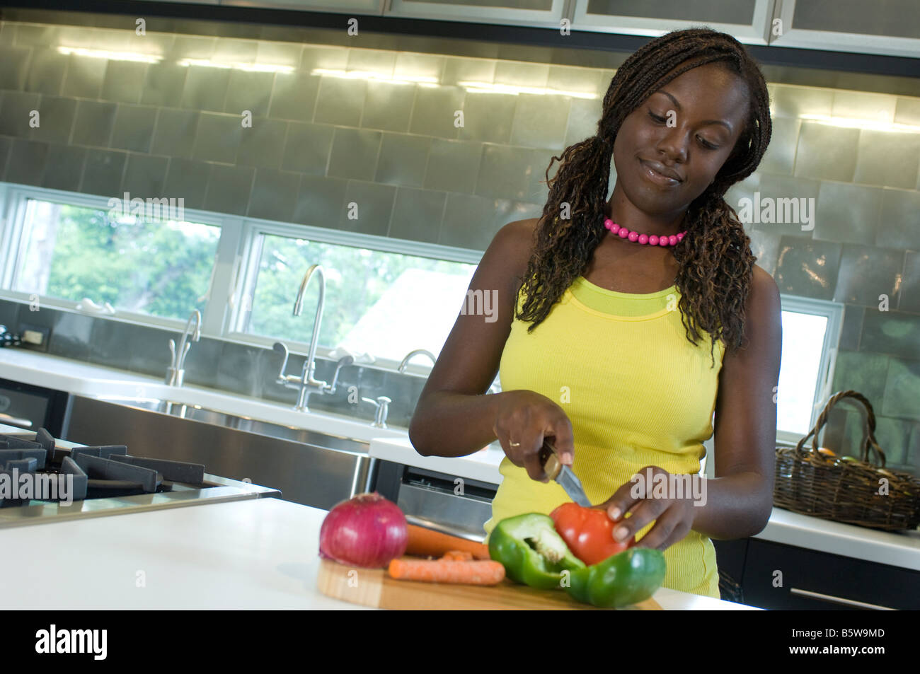 Teenage girl cutting vegetables Stock Photo - Alamy