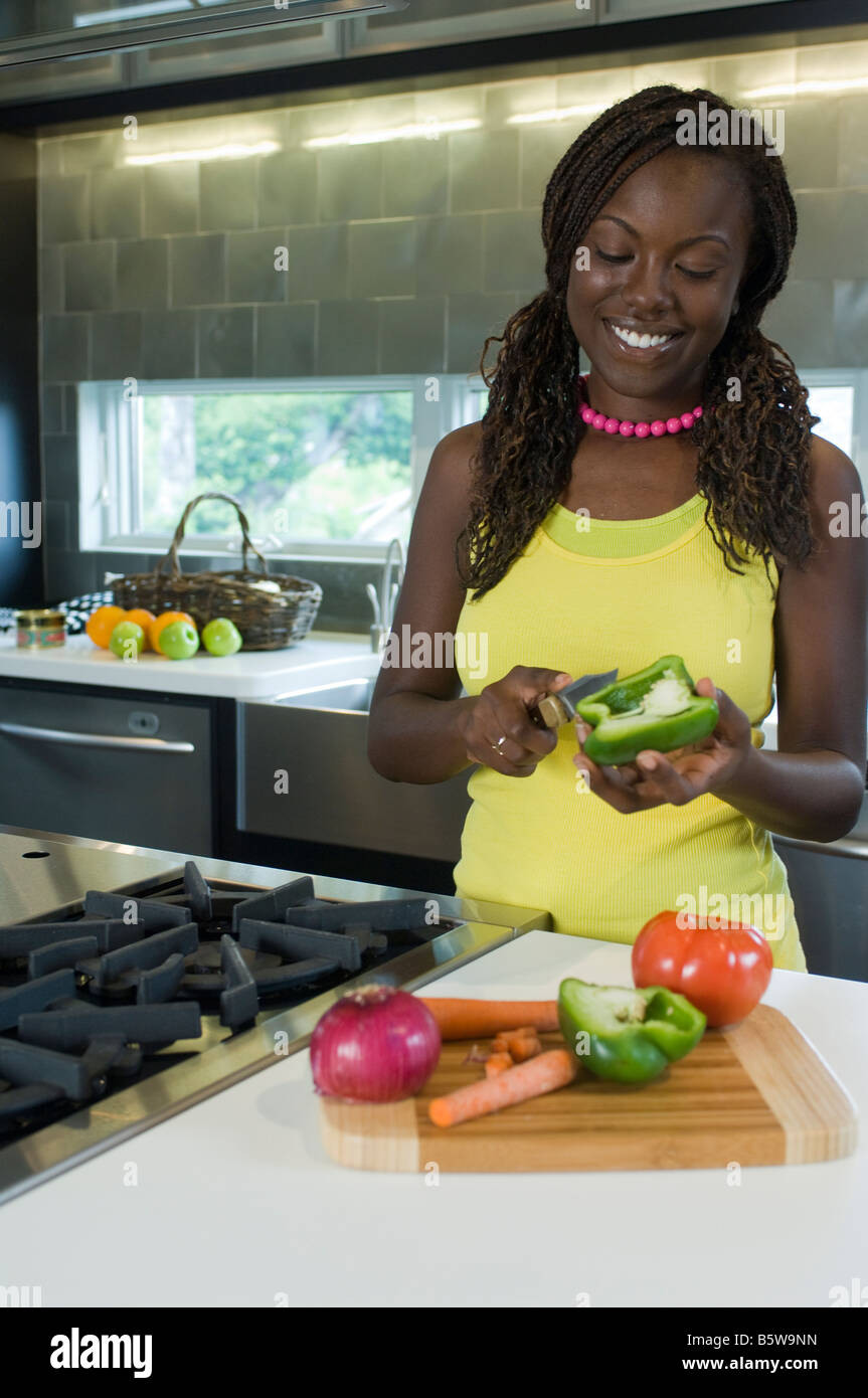 Teenage girl cutting vegetables Stock Photo - Alamy