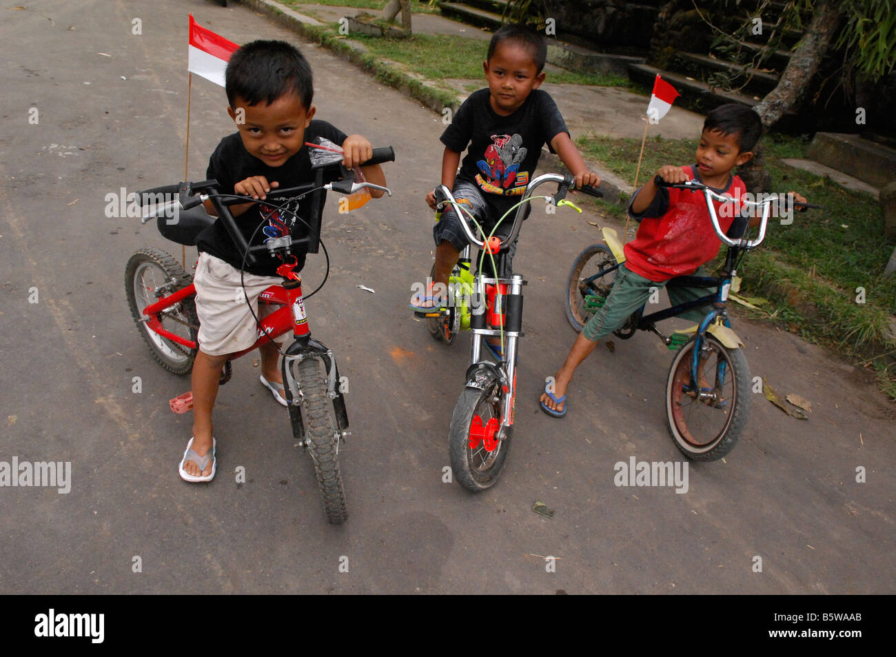Balinese boy, having fun with thier bicycle before indonesian ...