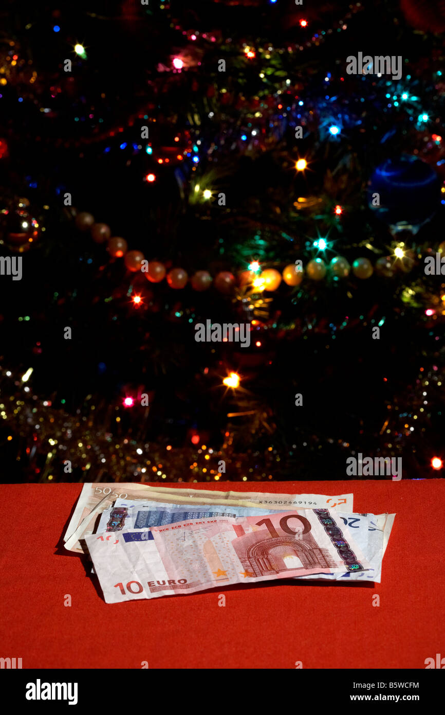 pile of euro cash in front of christmas tree Stock Photo - Alamy