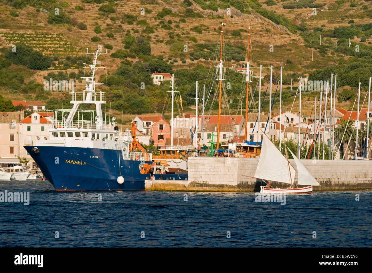 Traditional Croatian sailing fishing boat in front of Komiza Harbor ...