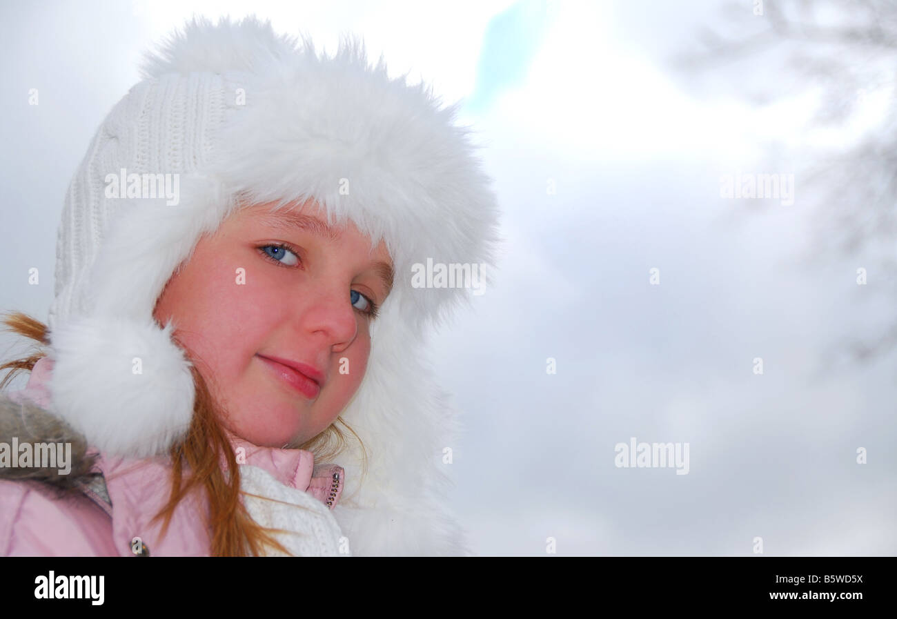 Portrait of young girl wearing white winter hat outside Stock Photo - Alamy