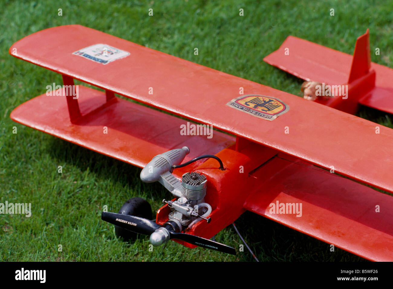 A Remote-controlled Model Airplane with a Doll Pilot landing on a ...