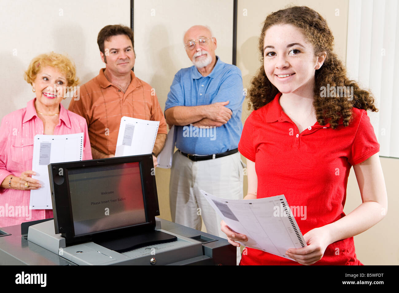 Late teen girl voting in her first election as her family looks on ...