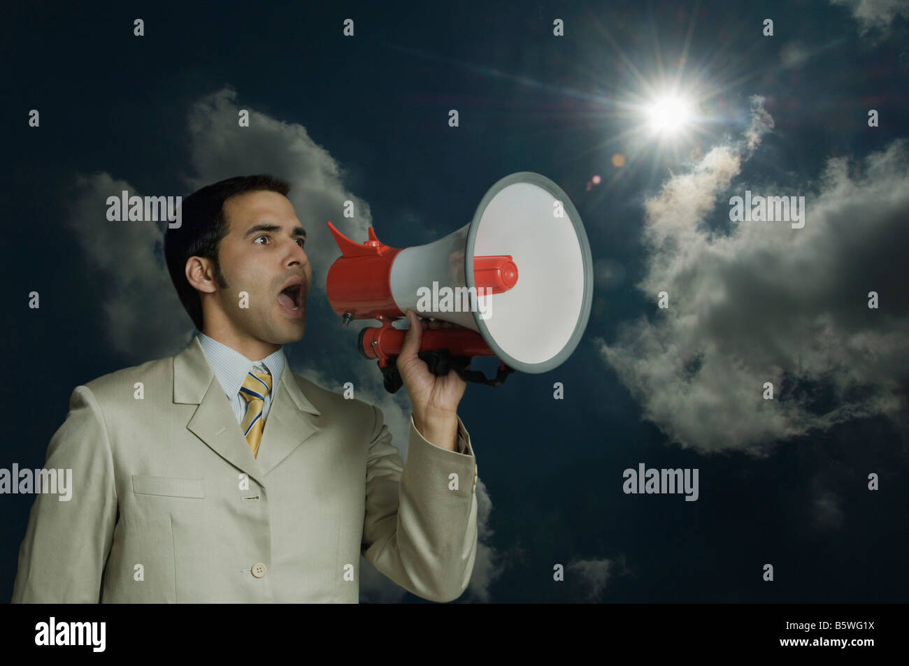 Businessman shouting into a megaphone Stock Photo - Alamy