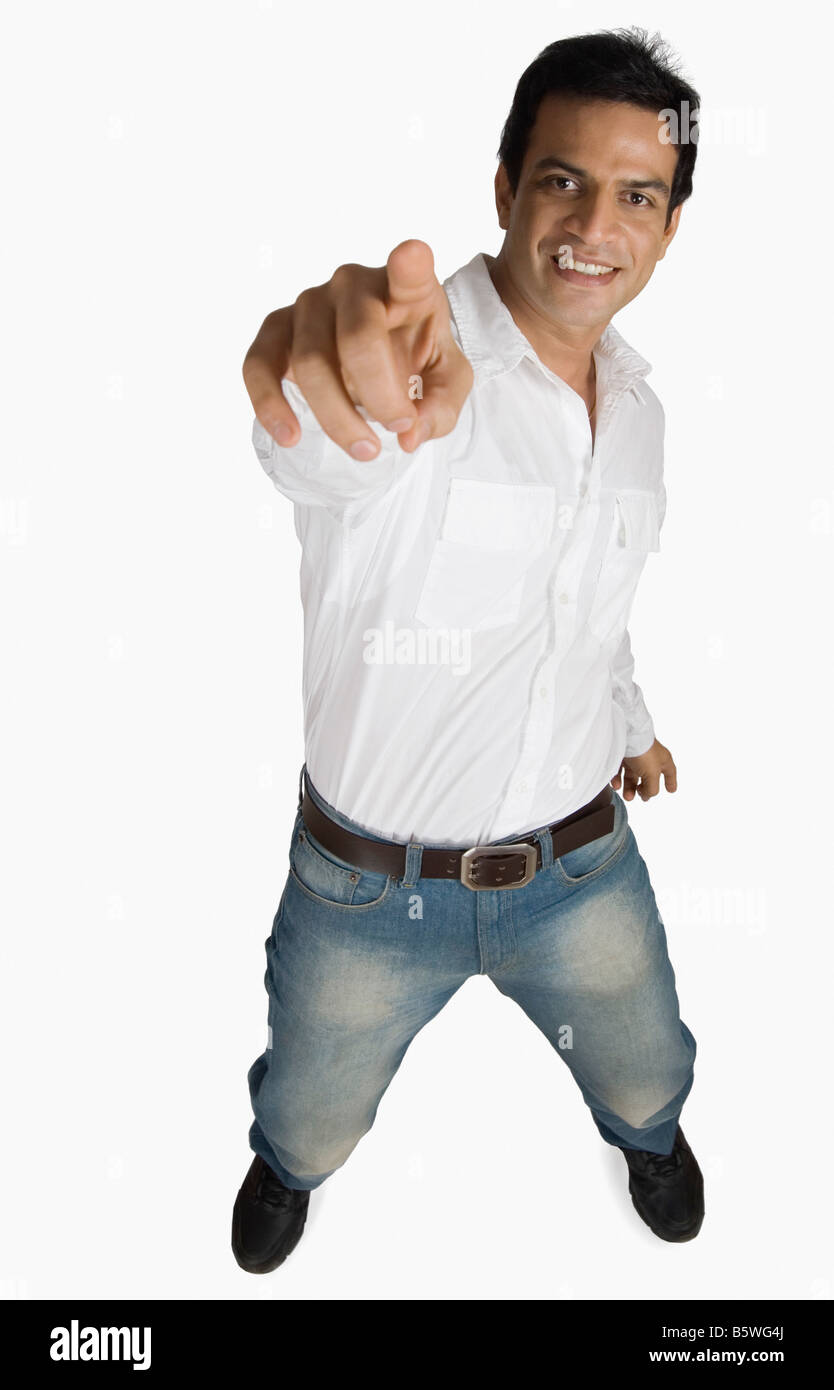 Portrait of a young man smiling and pointing Stock Photo - Alamy