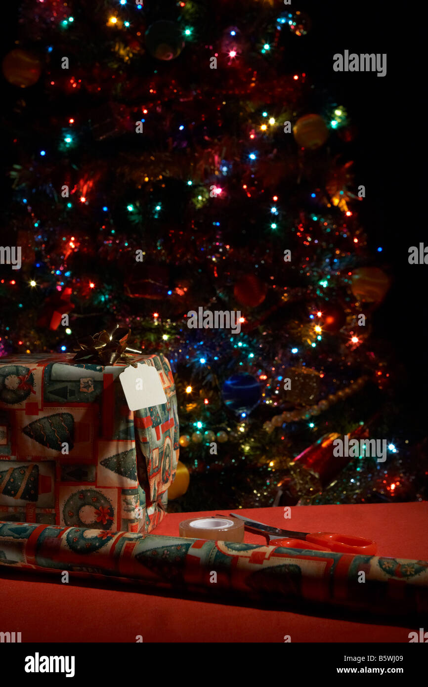 wrapped christmas present with wrapping paper tape and scissors in ...