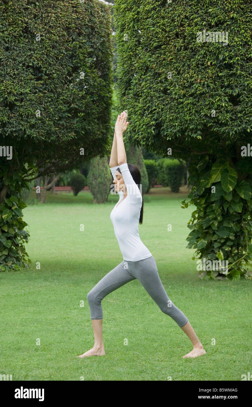 Woman exercising in a park Stock Photo - Alamy
