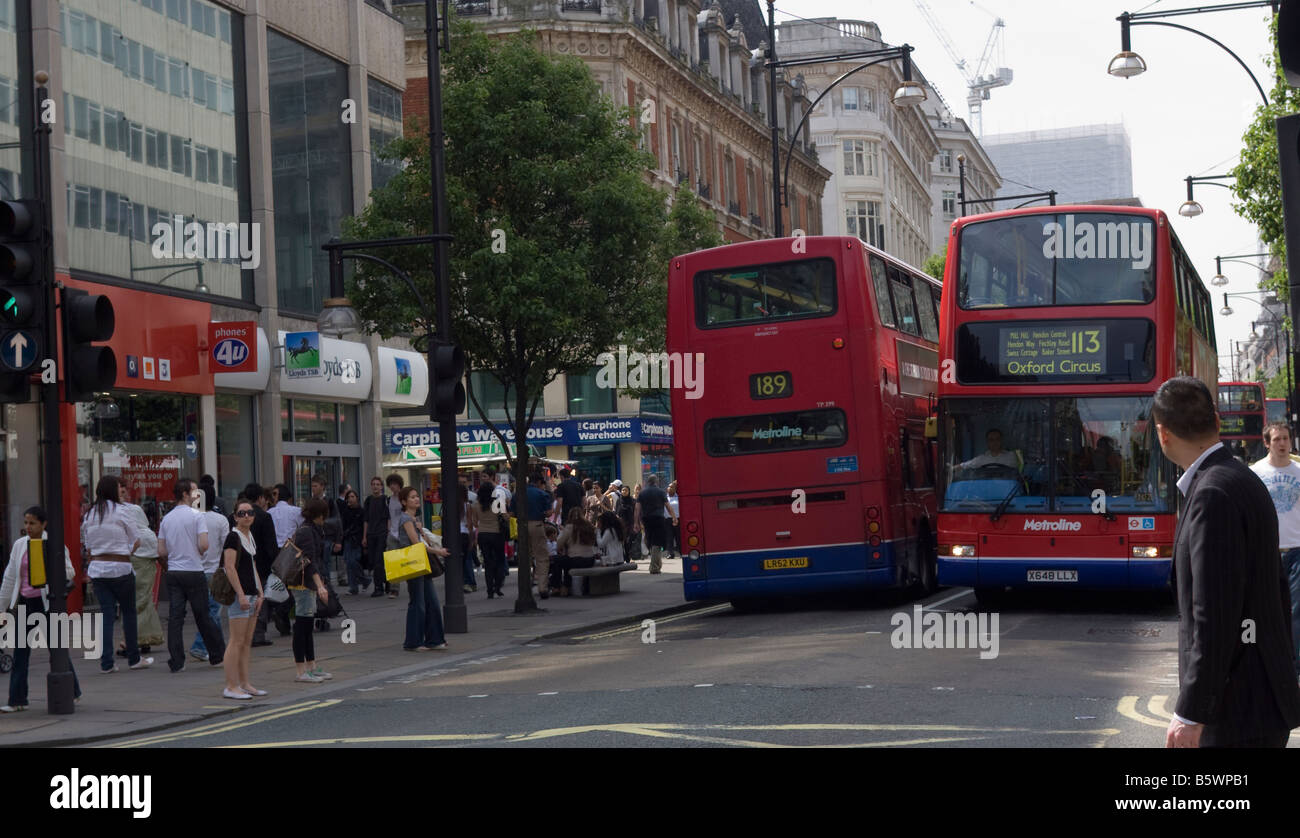 Two Red London buses pass in Oxford Street London GB UK Stock Photo - Alamy