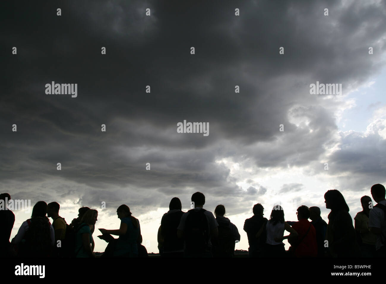 silhouette many people against open space dramatic dark sky Stock Photo ...