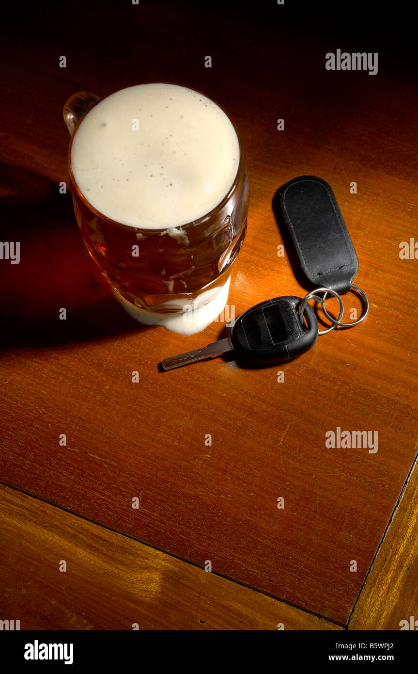 Pint of beer with car keys Stock Photo - Alamy