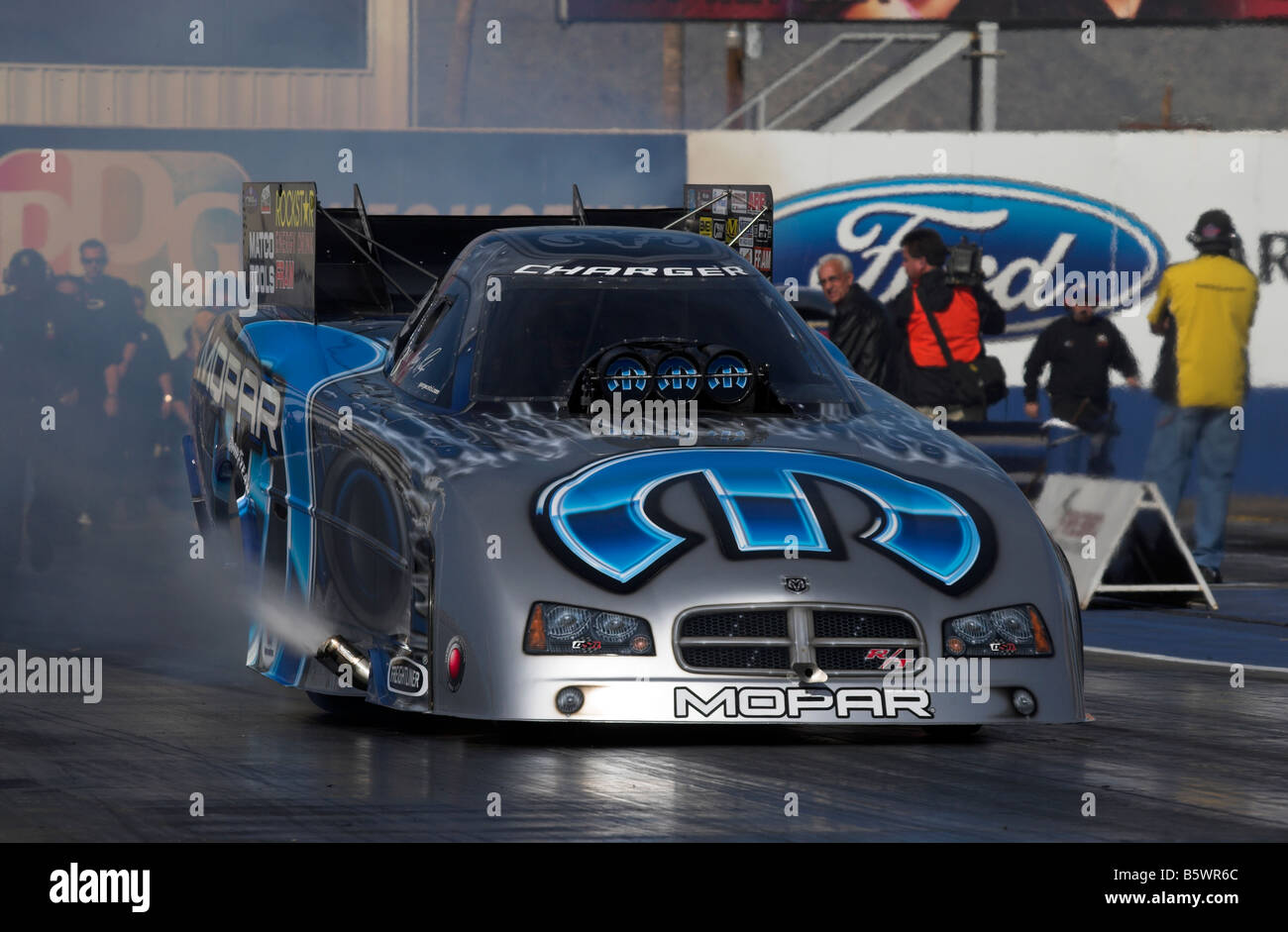 The Mopar NHRA funny car of Gary Sclezi burns out at the line, Firebird ...