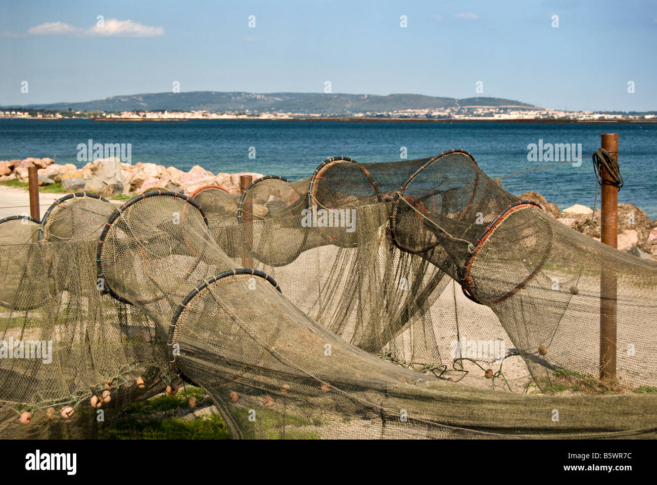 Fishing nets drying on the shores of the Bassin de Thau lagoon with ...