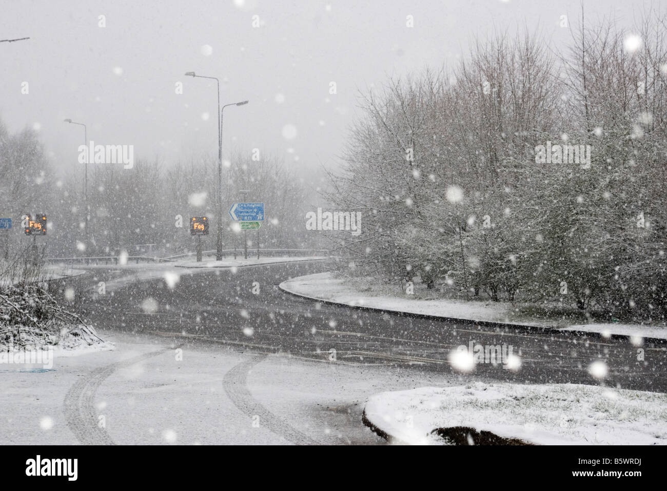Heavy Snow Falling On A Road in the uk Stock Photo - Alamy