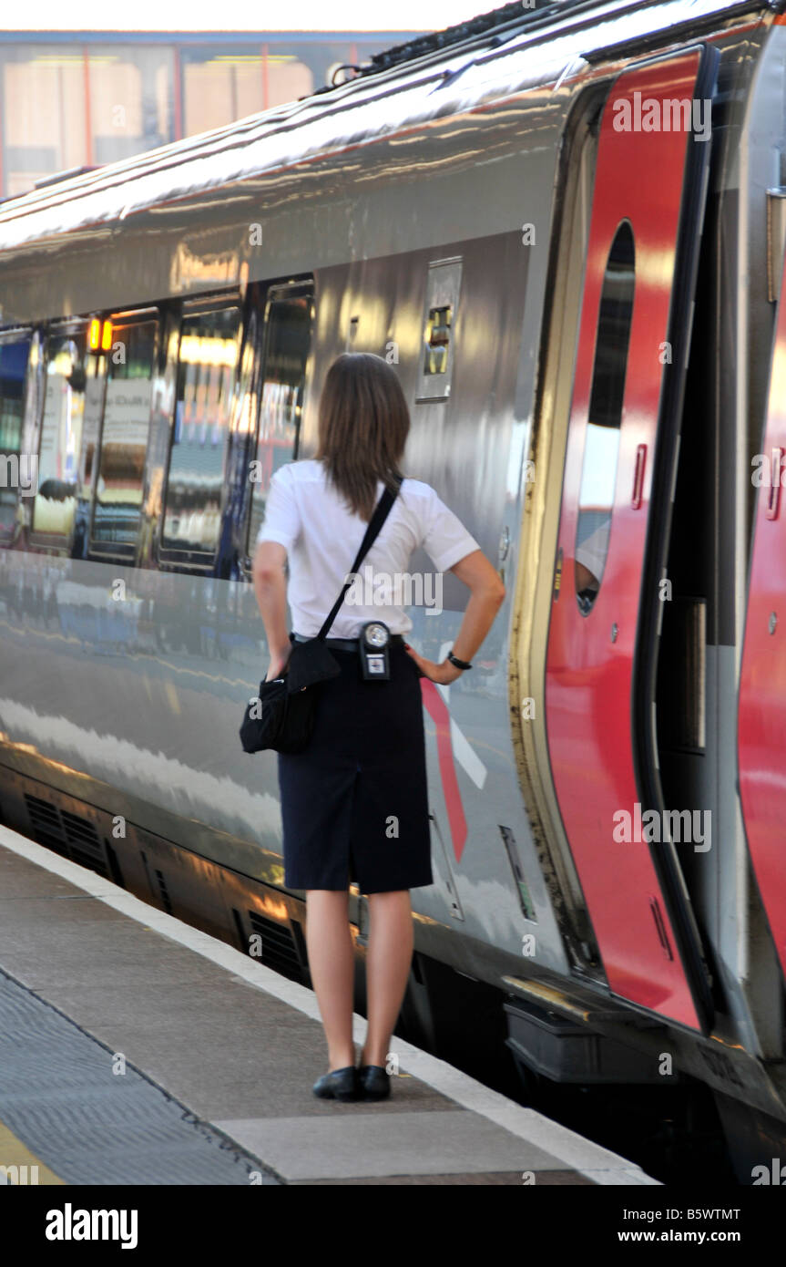 The train conductor checking passengers boarding the train Stock Photo ...