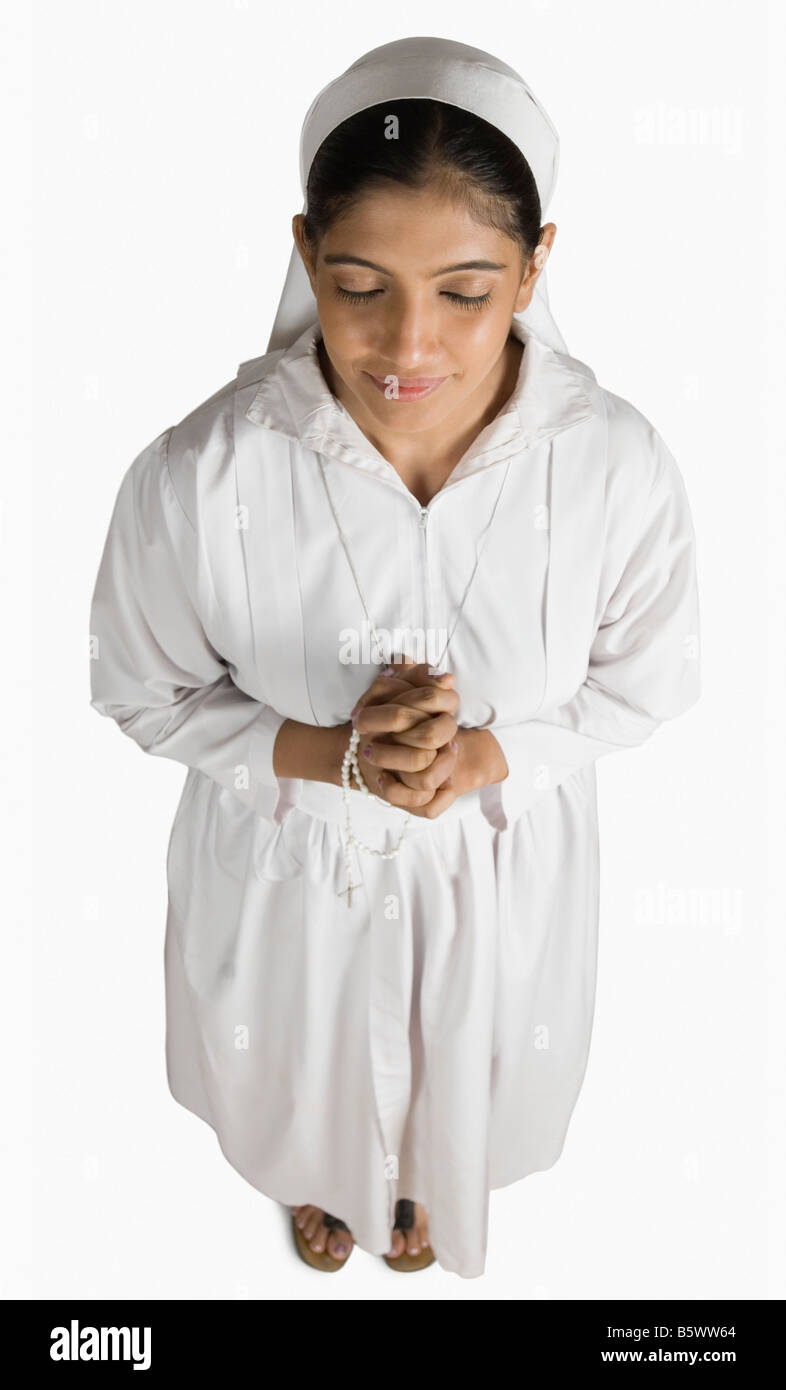 Praying nun holding rosary Cut Out Stock Images & Pictures - Alamy
