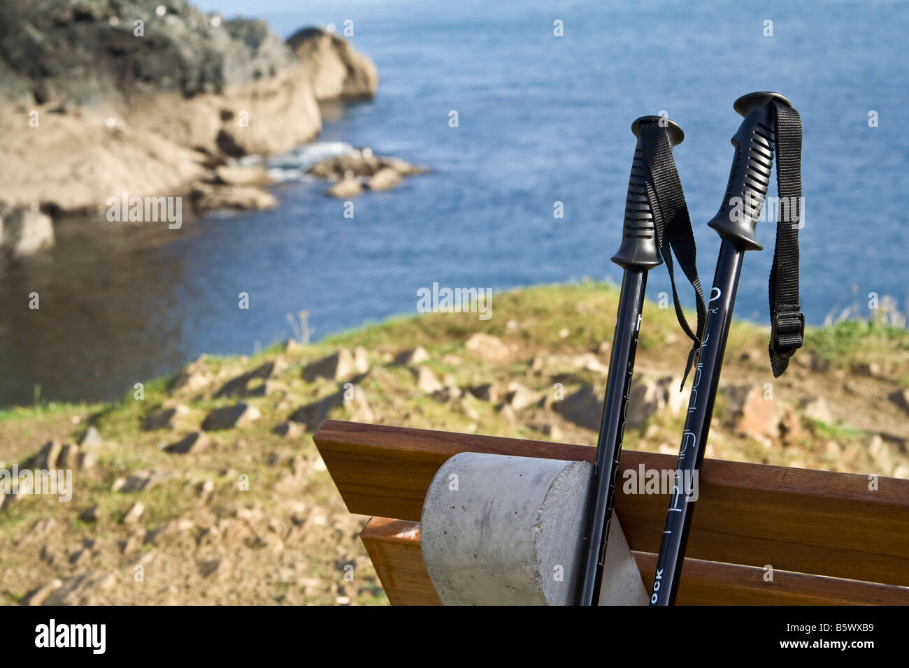 A pair of walking sticks leaning against a bench, UK Stock Photo - Alamy