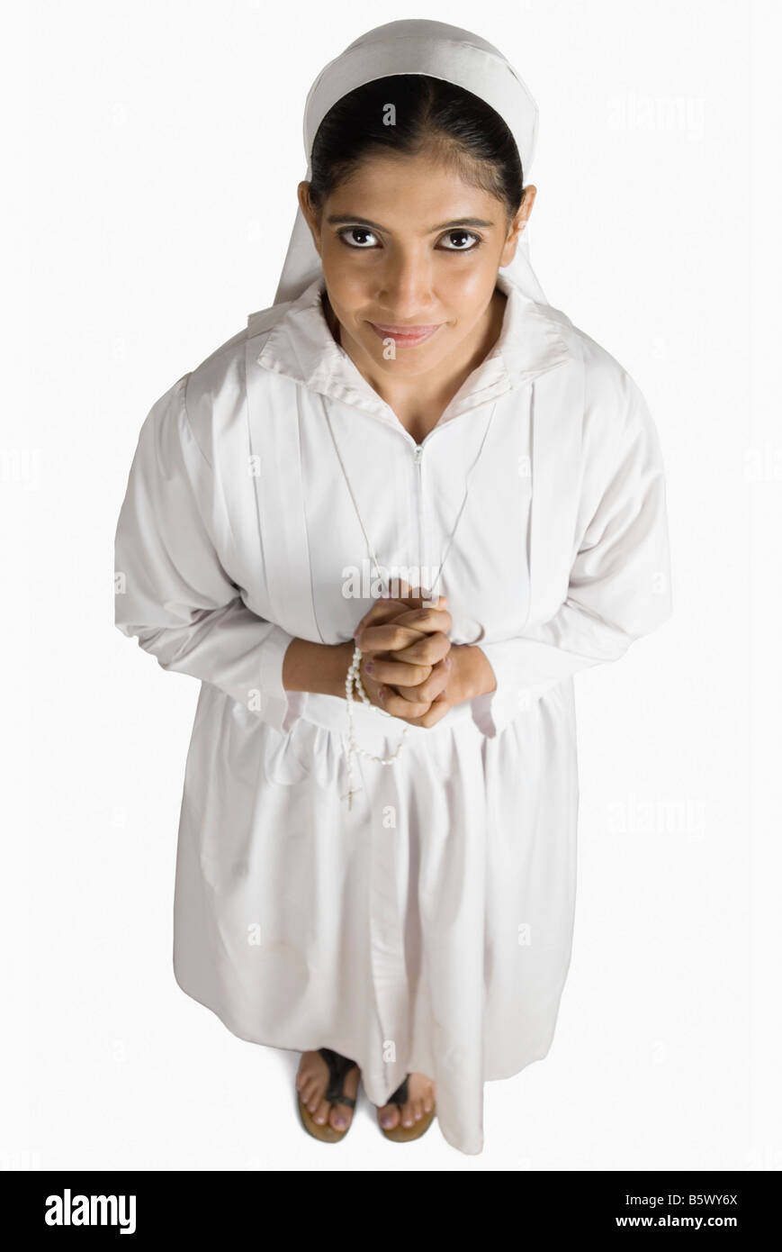 Portrait of a nun standing in a prayer position Stock Photo - Alamy