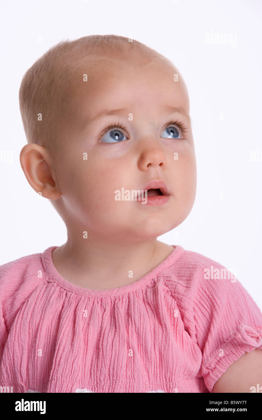 Portrait of a cute baby girl looking up Stock Photo - Alamy