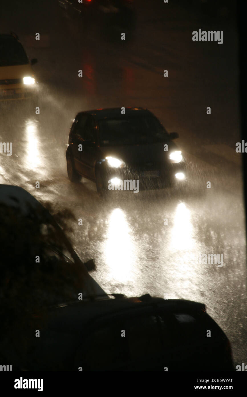 fast car driving in heavy rain at night in town Stock Photo - Alamy