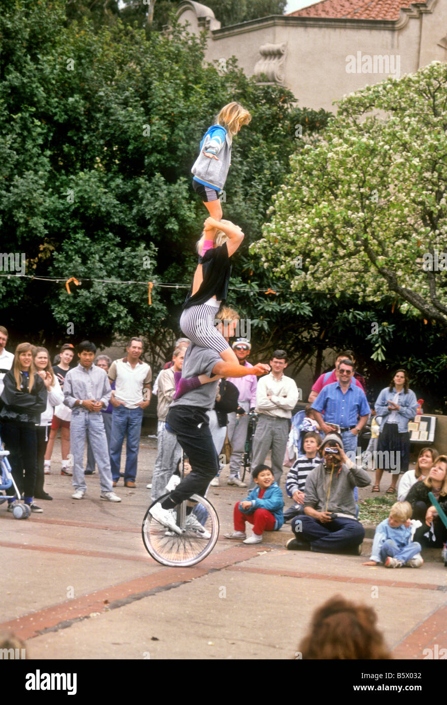 Three people ride on one unicycle Stock Photo - Alamy