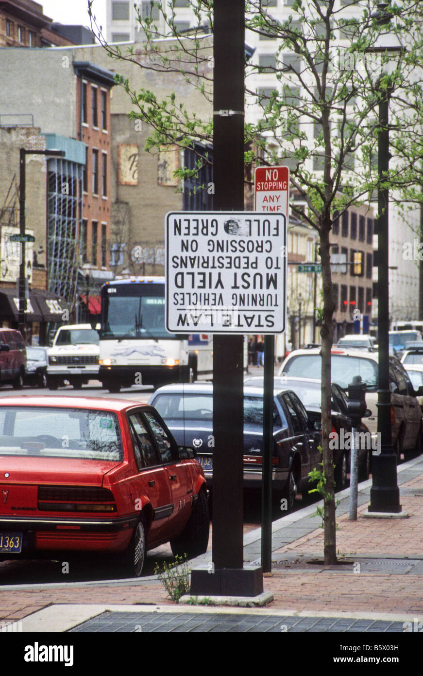 Traffic sign mounted upside down on city street Stock Photo - Alamy