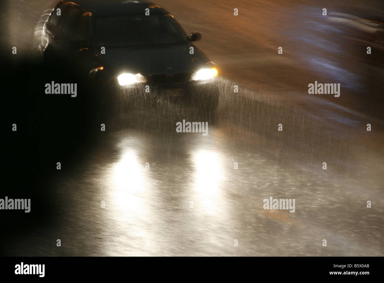 fast car driving in heavy rain at night in town Stock Photo - Alamy